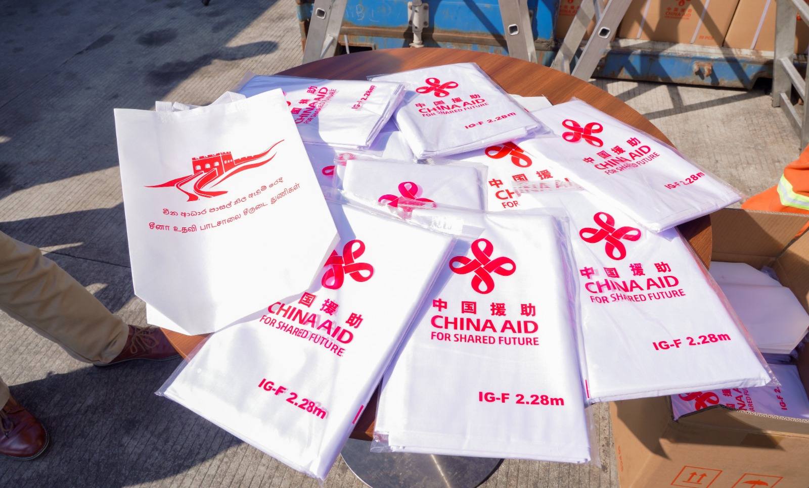 China hands over school uniform material for 2026 (Pics) – Sri Lanka ...